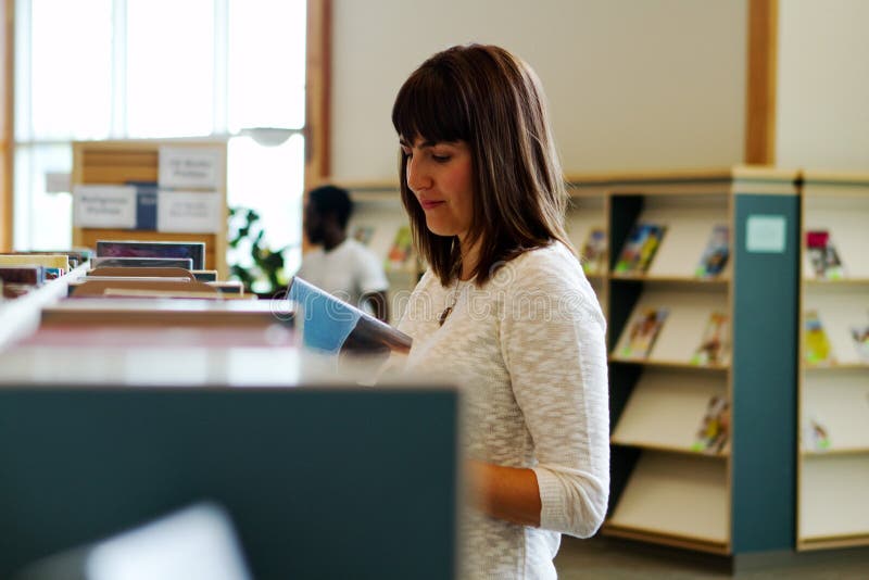 Library Patrons Looking at Books Stock Photo - Image of education ...
