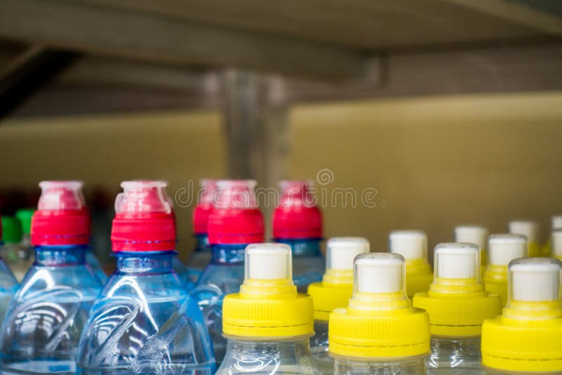 Lid Plastic Water Bottle in the Market. Multi-colored Plastic Bottle ...