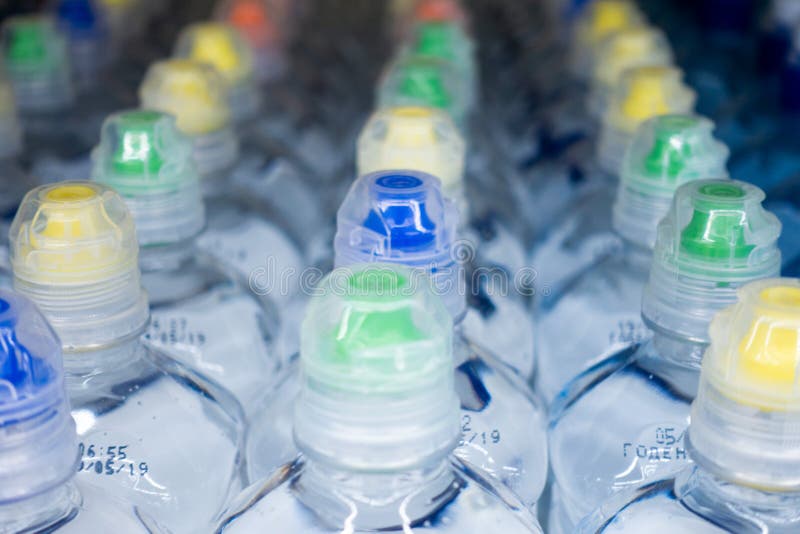 Lid Plastic Water Bottle in the Market. Multi-colored Plastic Bottle ...