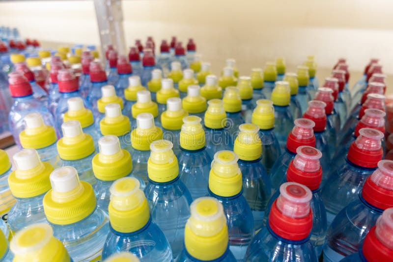 Lid Plastic Water Bottle in the Market. Multi-colored Plastic Bottle ...