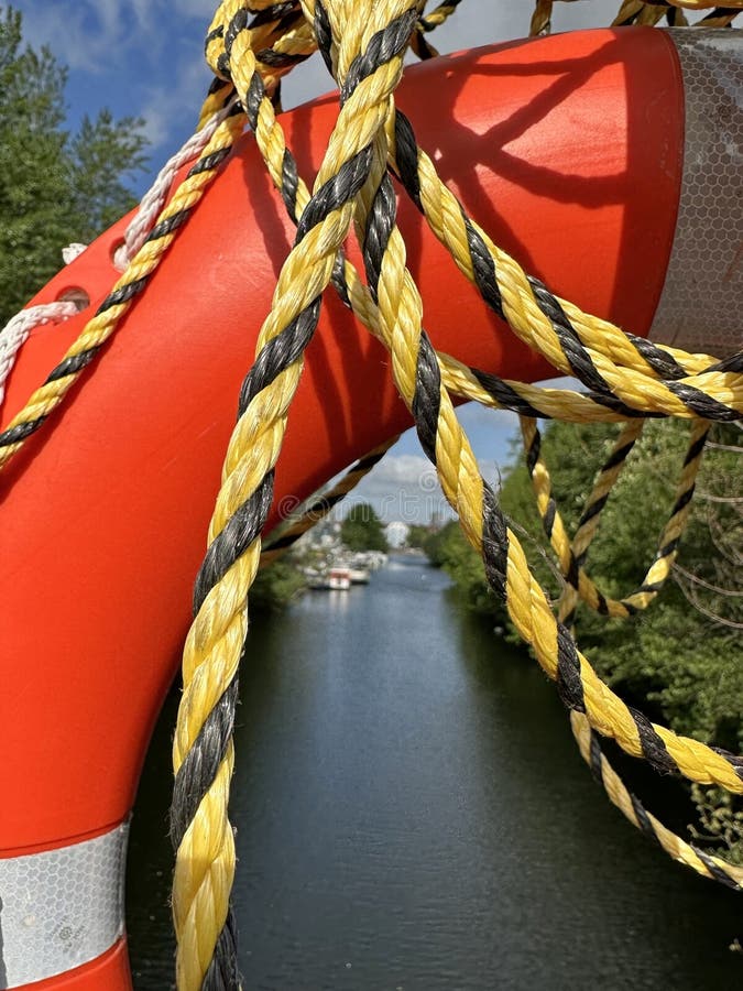 Life Buoy with a Rope Over the River Stock Image - Image of vertical ...