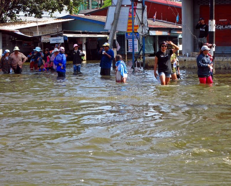 People Walk through the Flooded Roads Editorial Photo - Image of badly ...