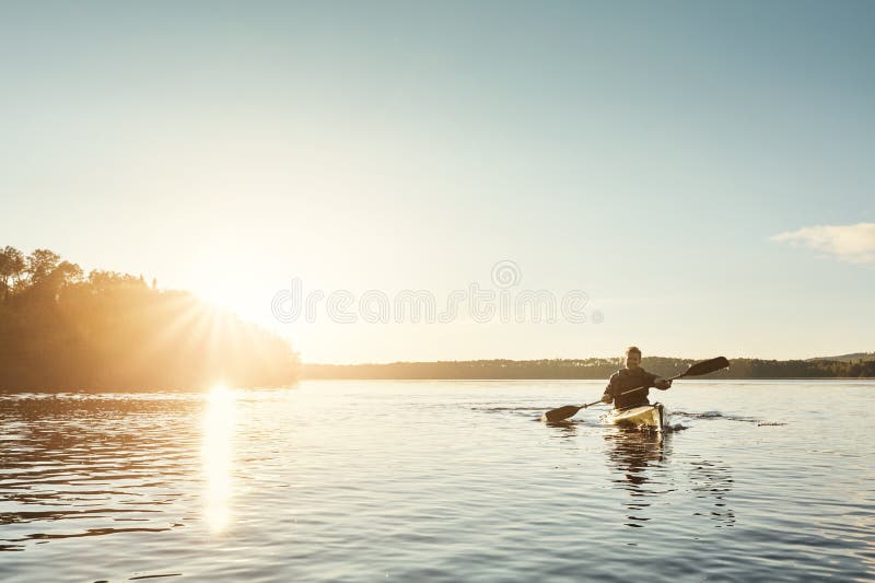 Life is Good on the Water. a Young Man Kayaking on a Lake Outdoors ...
