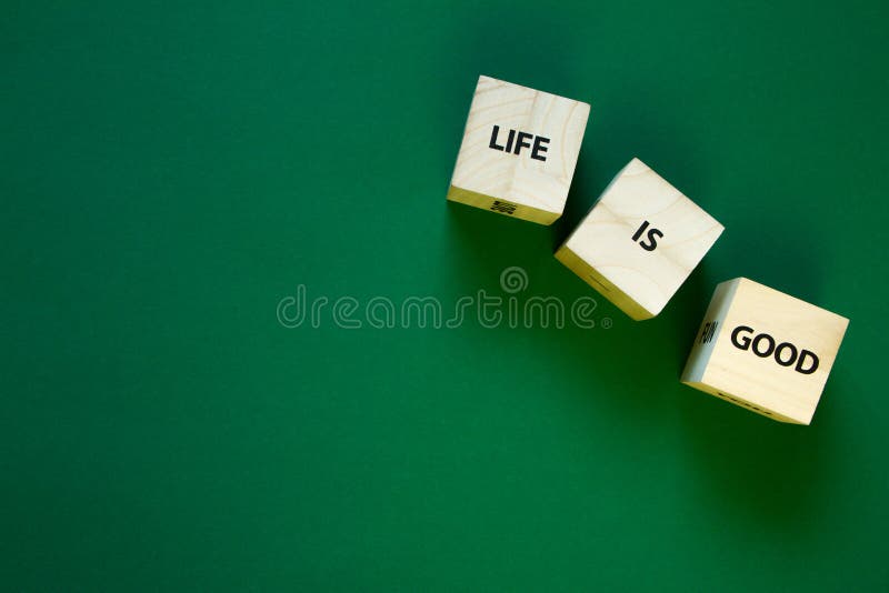 Life is Good Words on the Faces of Wooden Cubes on a Green Background ...