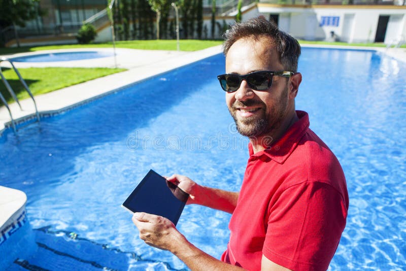 Life Guard Using a Tablet at the Poolside. Stock Photo - Image of home ...