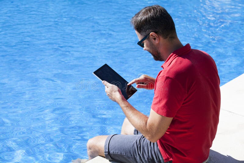 Life Guard Using Tablet Sitting on the Poolside. Stock Photo - Image of ...