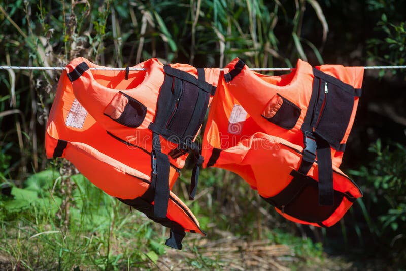 Life Jackets Hang on a Rope on the Shore Against the Backdrop of ...
