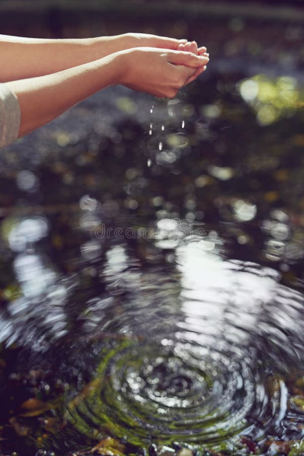 Life in Liquid Form. a Woman Washing Her Hands in a Pond. Stock Image ...