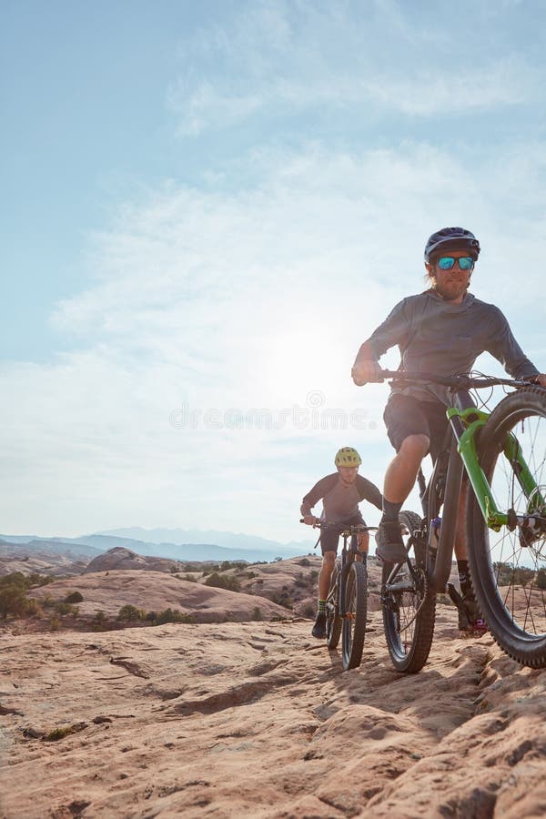 Life is One Awesome Ride. Two Athletic Men Mountain Biking through the ...