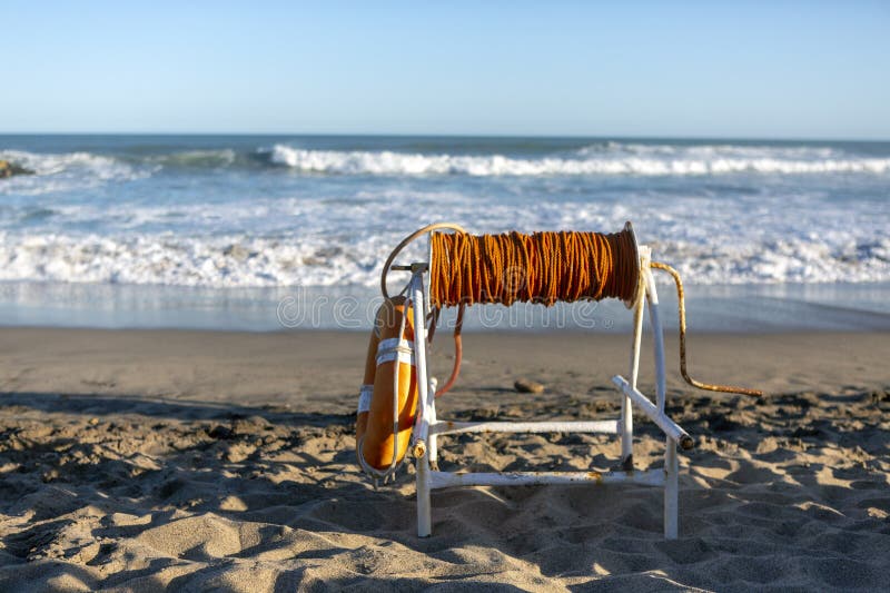 Life Ring with Coil of Rope, at the Edge of the Sea Stock Photo - Image ...