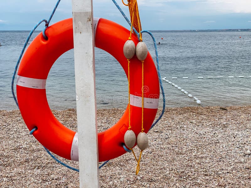 Life Ring on the Seashore by the Water Stock Photo - Image of equipment ...