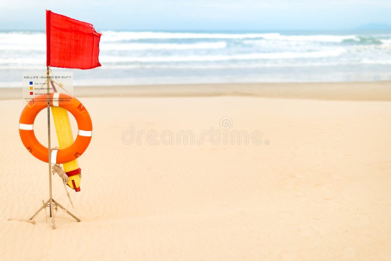 Life Saving Objects with Red Flag on Beach. Stock Photo - Image of ...