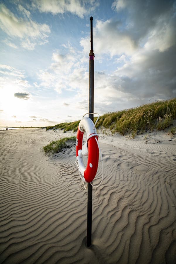 Life Saving Ring on a Beach in the Evening Light Stock Photo - Image of ...