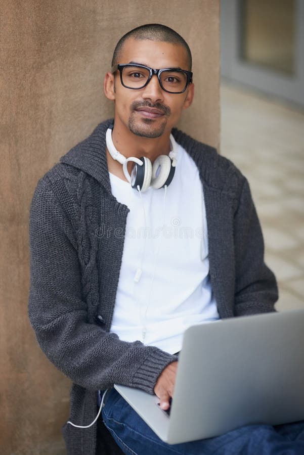 The Life of a Student. Portrait of a College Student Using His Laptop ...