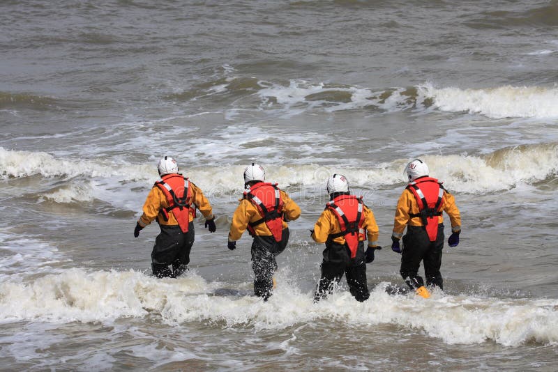 Lifeboat Crew stock image. Image of orange, walking, ocean - 5873909