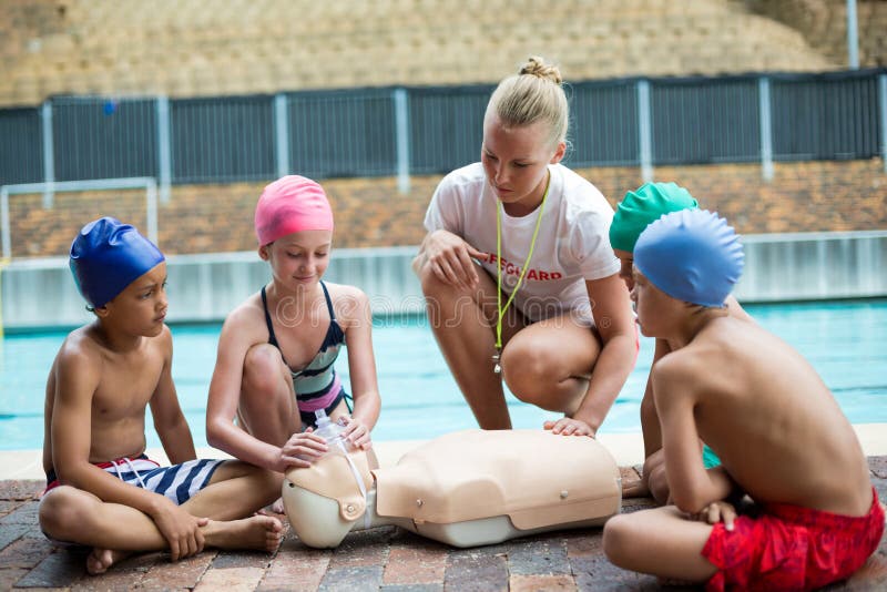 Lifeguard Assisting Children during Rescue Training Stock Image - Image ...