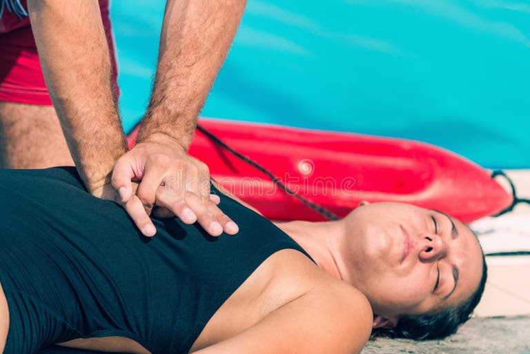 Lifeguard doing CPR stock image. Image of color, male - 222784503