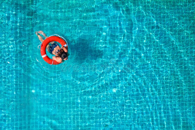 Lifeguard Girl Training with a Life Preserver Swimming in the Pool ...