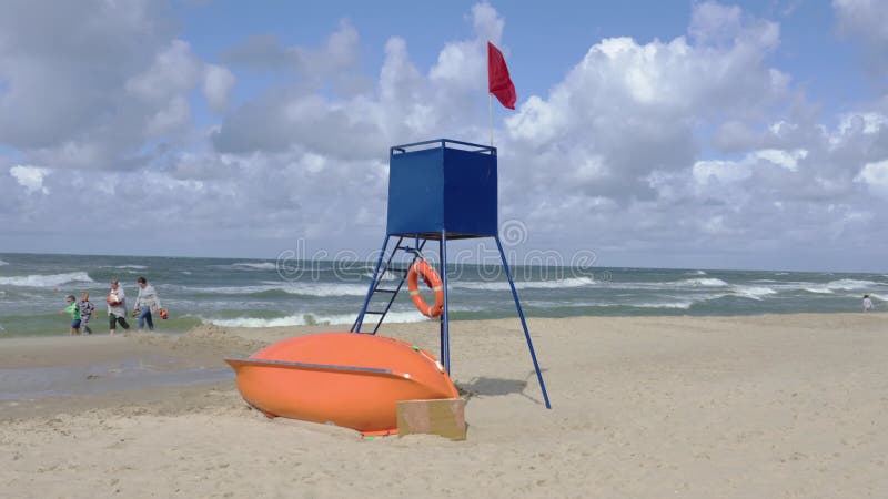 Lifeguard Post with a Ref Flag on it Informing about the Danger of the ...