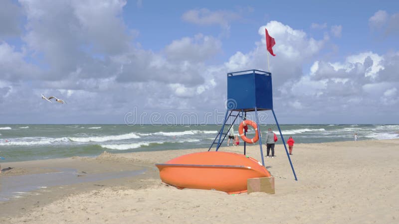Lifeguard Post with a Ref Flag on it Informing about the Danger of the ...