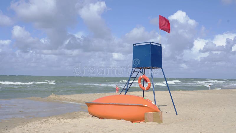Lifeguard Post with a Ref Flag on it Informing about the Danger of the ...