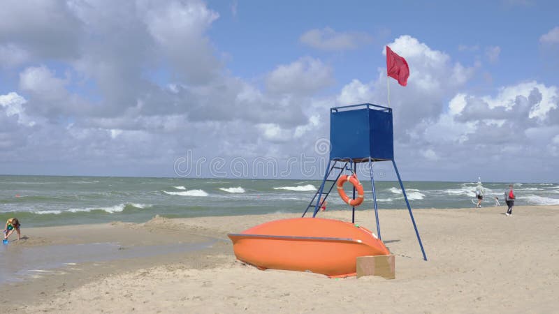 Lifeguard Post with a Ref Flag on it Informing about the Danger of the ...