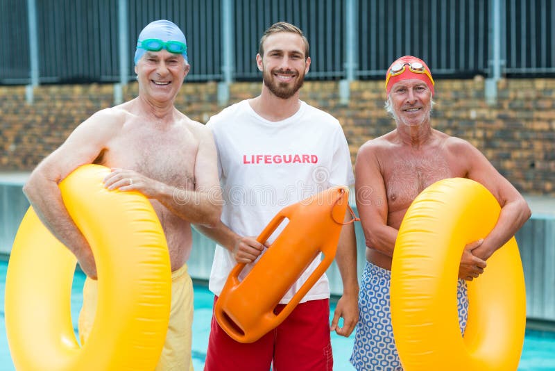 Lifeguard with Senior Swimmers at Poolside Stock Photo - Image of ...
