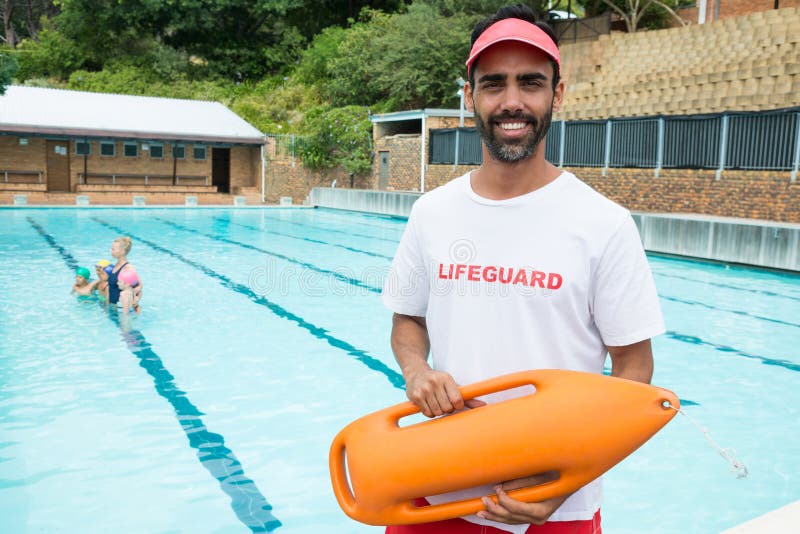 Smiling Lifeguard Standing with Whistle Near Poolside Stock Photo ...