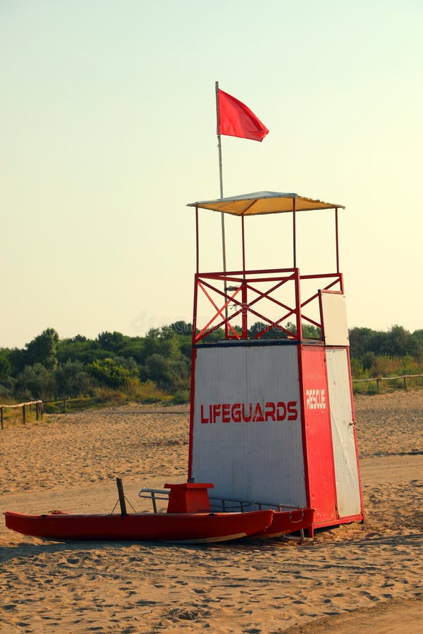 Lifeguard Tower with Red Flag Flying High on Beach Stock Photo - Image ...