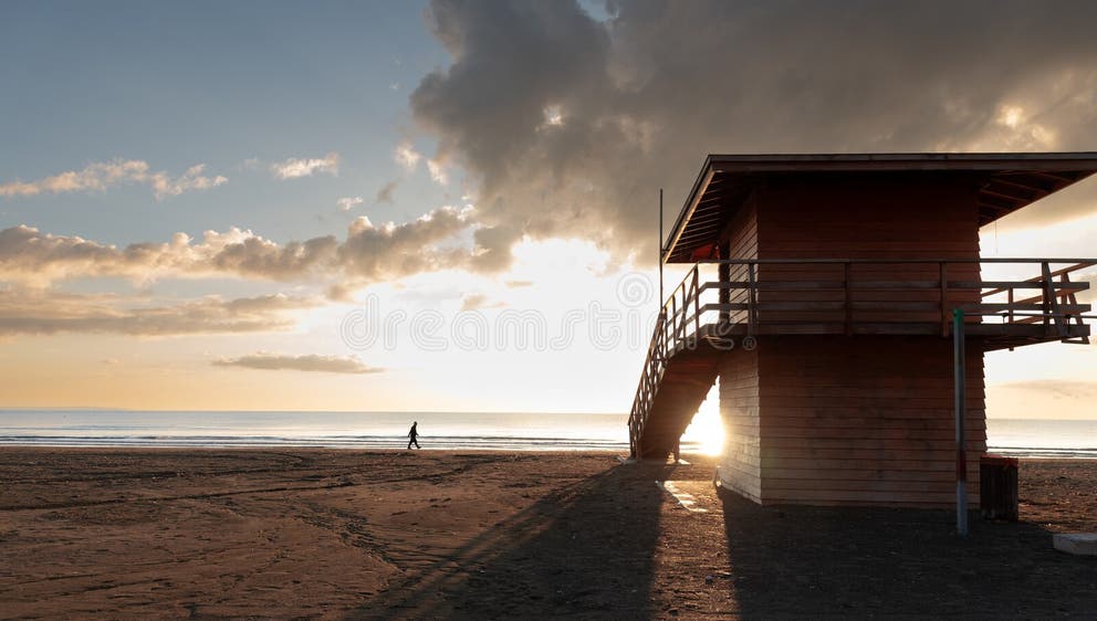 Lifeguard Tower Watching Over Empty Beach at Sunset with Dramatic ...