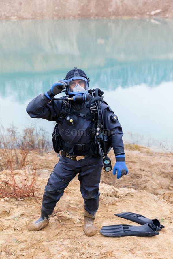 A Lifeguard in a Wetsuit is Preparing To Dive into the Pond. Search at ...