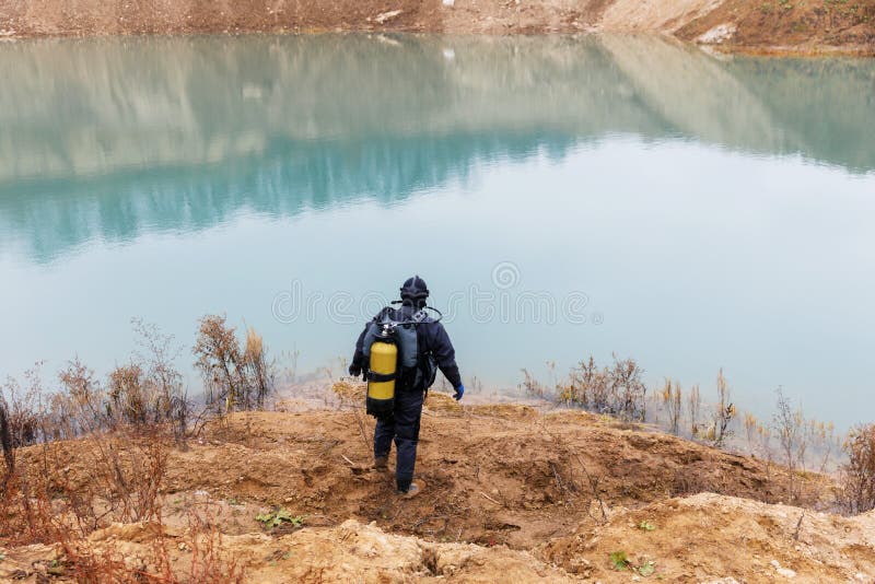 A Lifeguard in a Wetsuit is Preparing To Dive into the Pond. Search at ...