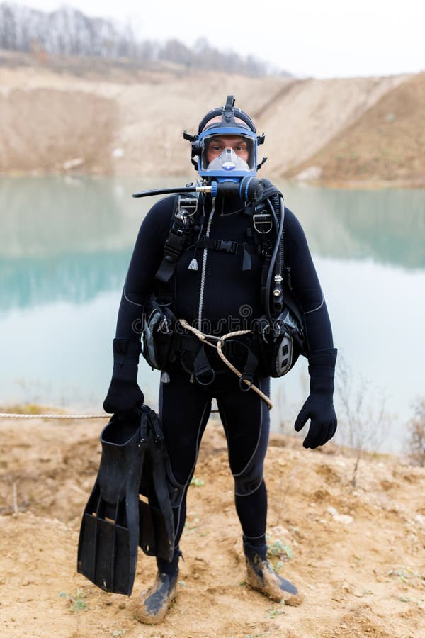 A Lifeguard in a Wetsuit is Preparing To Dive into the Pond. Search at ...