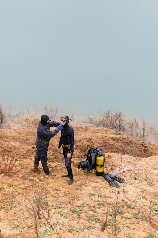 Lifeguard in a Wetsuit To Work Underwater. Search at the Bottom of the ...