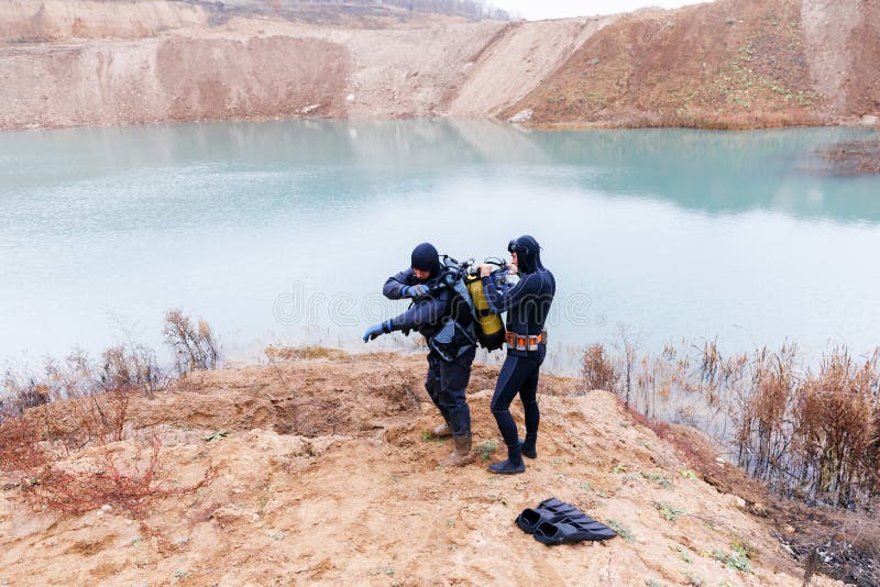 Lifeguard in a Wetsuit To Work Underwater. Search at the Bottom of the ...