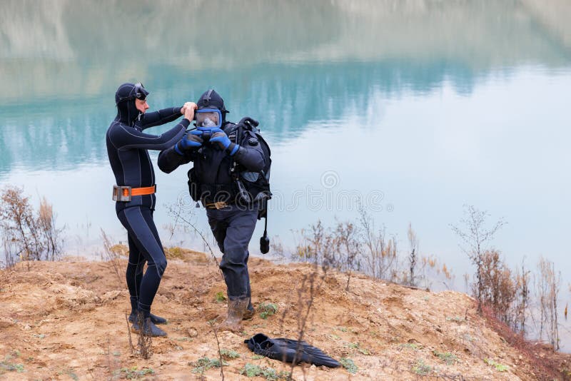 Lifeguard in a Wetsuit To Work Underwater. Search at the Bottom of the ...