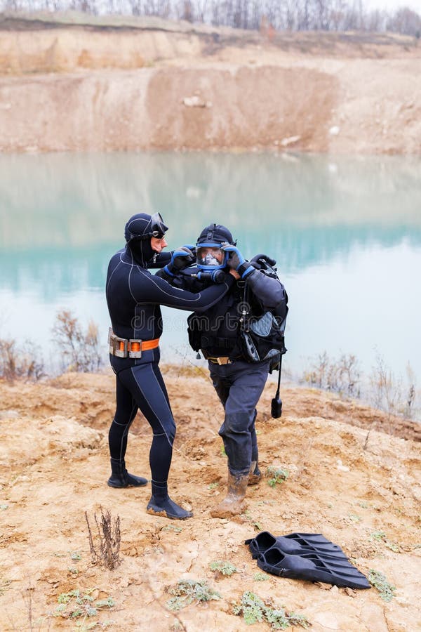 Lifeguard in a Wetsuit To Work Underwater. Search at the Bottom of the ...
