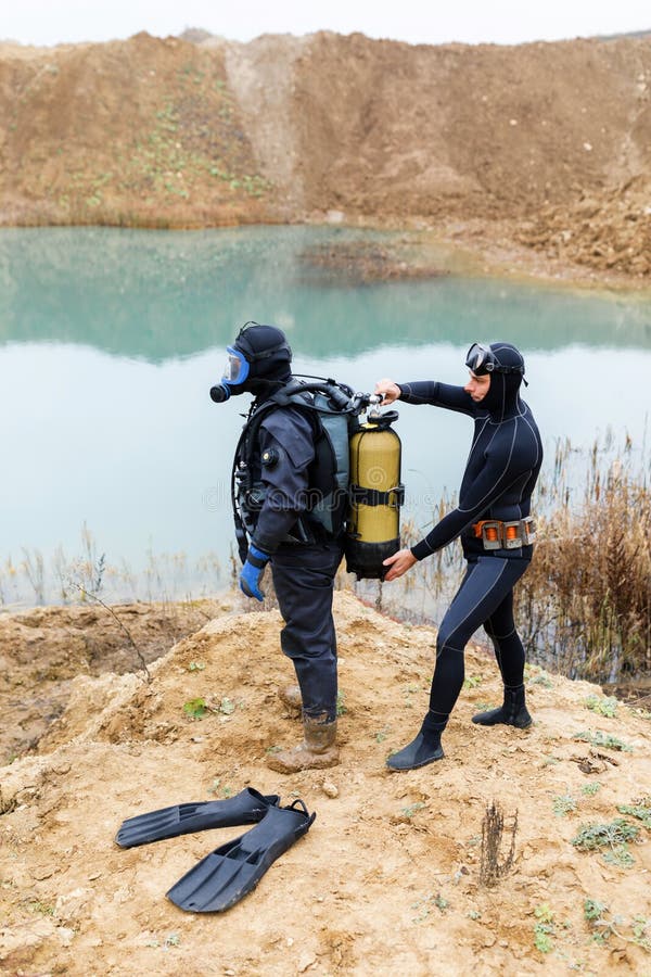 Lifeguard in a Wetsuit To Work Underwater. Search at the Bottom of the ...