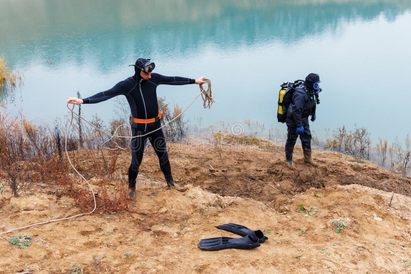 Lifeguard in a Wetsuit To Work Underwater. Search at the Bottom of the ...