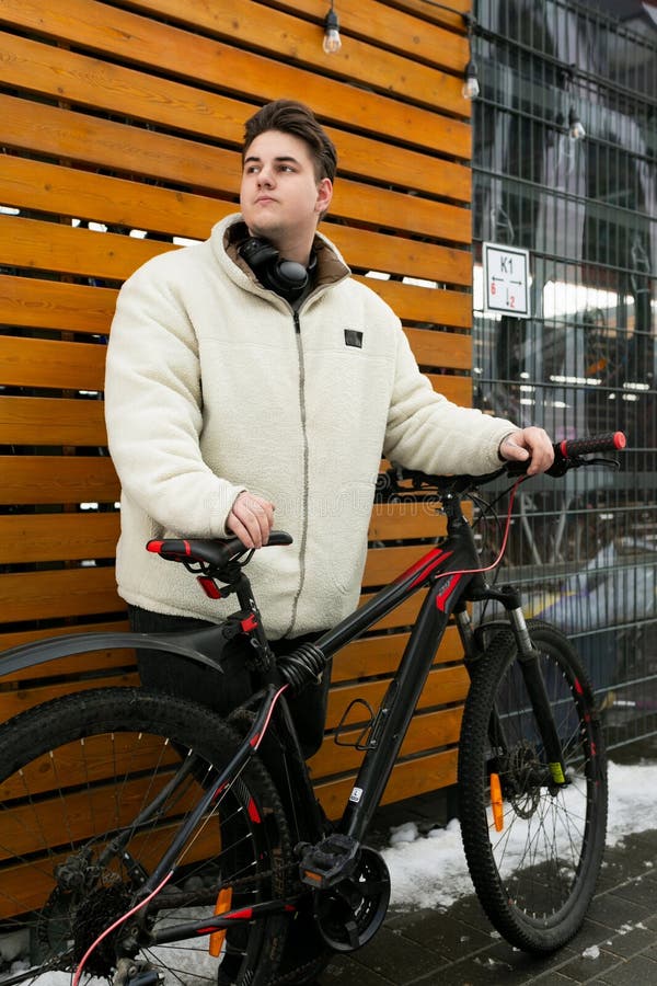 Cute Young Guy Riding a Bike Around the City in Winter Stock Photo ...