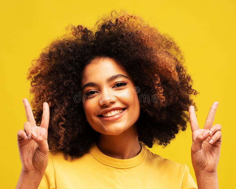 Shiny African Woman Wear Yellow T Shirt Showing V Sign Stock Image