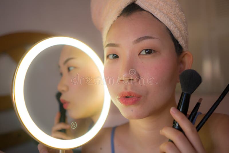 Lifestyle Portrait Of Young Beautiful And Happy Asian Woman Applying