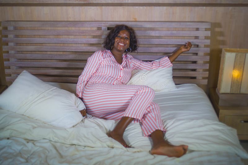 Young Happy And Beautiful Black African American Woman In Pajamas Lying