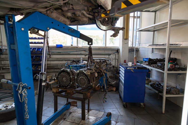 Lift Crane with Car Engine in Auto Service Workshop Stock Photo - Image ...
