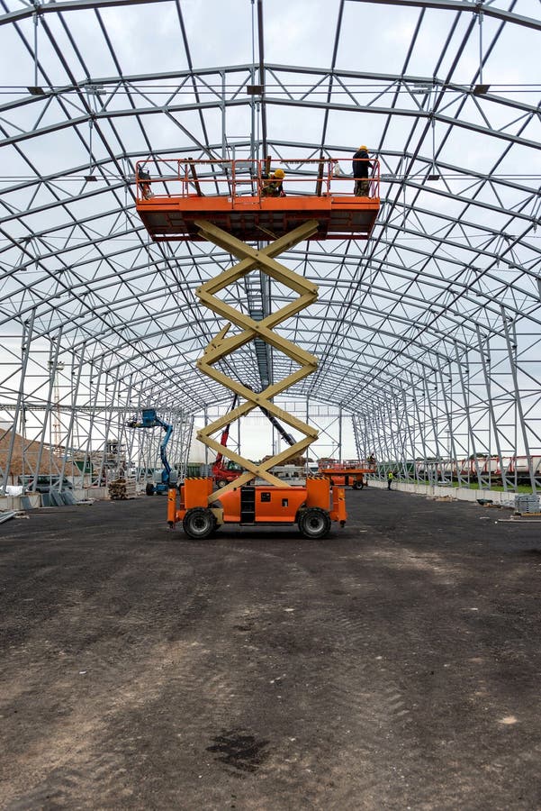 Lift with Platform Work in Warehouse Hangar Construction Field. Stock ...