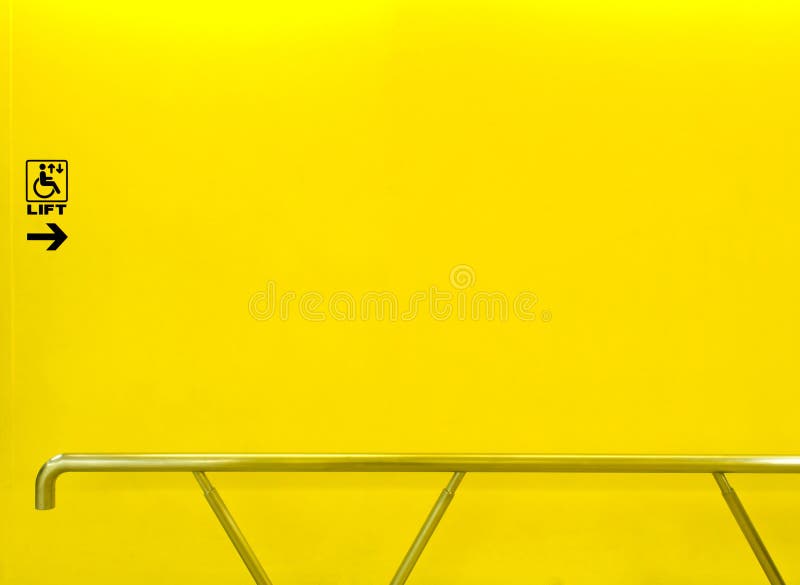 Lift Sign for Disabled on Yellow Wall with Handrail Stock Image - Image ...