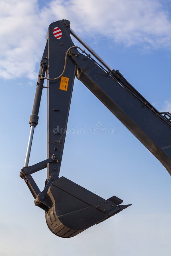 Lifting Boom and Bucket of a Black Excavator Against the Sky Stock ...
