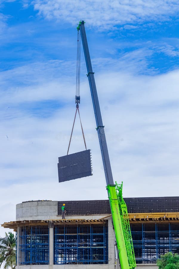 Lifting Crane and Modern Houses Under Construction Editorial ...