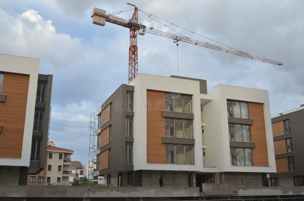Lifting Crane Over a Building with Workers Stock Image - Image of ...