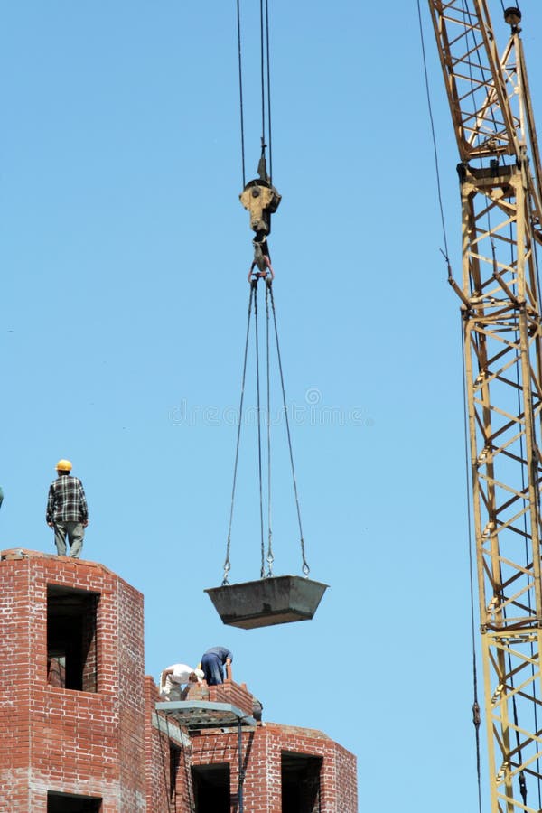 Lifting-crane Lifts a Bricks Stock Image - Image of hoist, construction ...